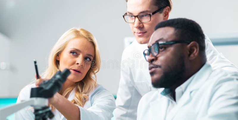 Medical Scientists Working in Lab. Doctor Teaching Interns To Make ...