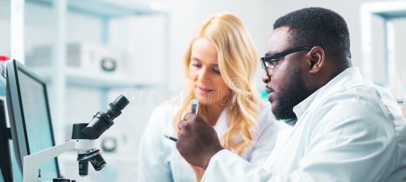 Medical Scientists Working in Lab. Doctor Teaching Interns To Make ...