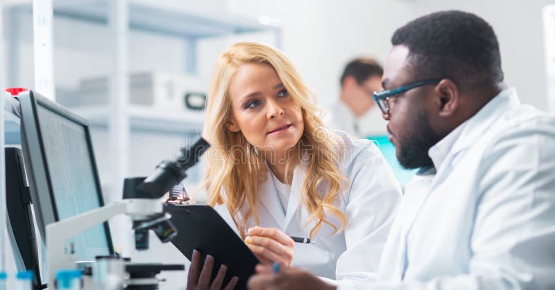 Medical Scientists Working in Lab. Doctor Teaching Interns To Make ...