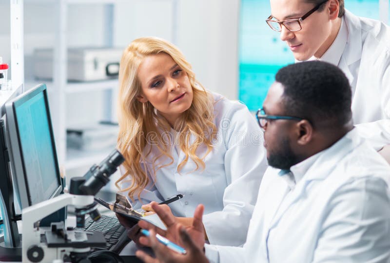 Medical Scientists Working in Lab. Doctor Teaching Interns To Make ...