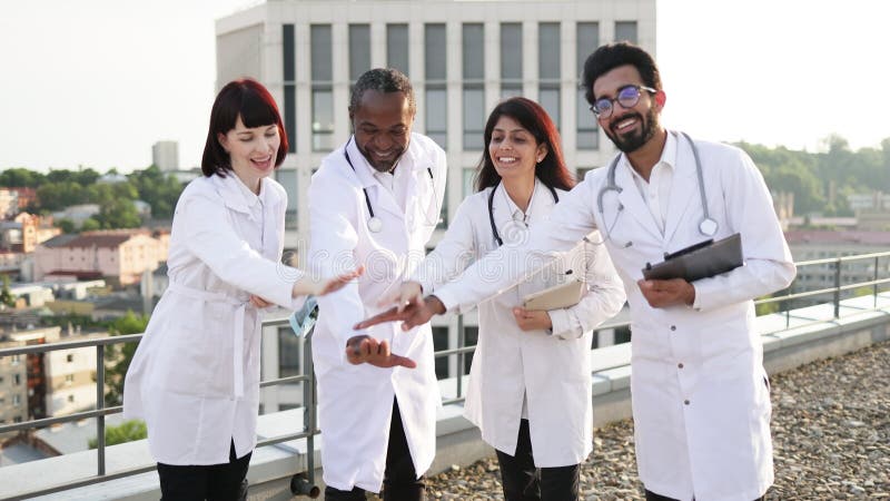 Medical Specialists Doctors Looking at Camera while Stacking Hands ...