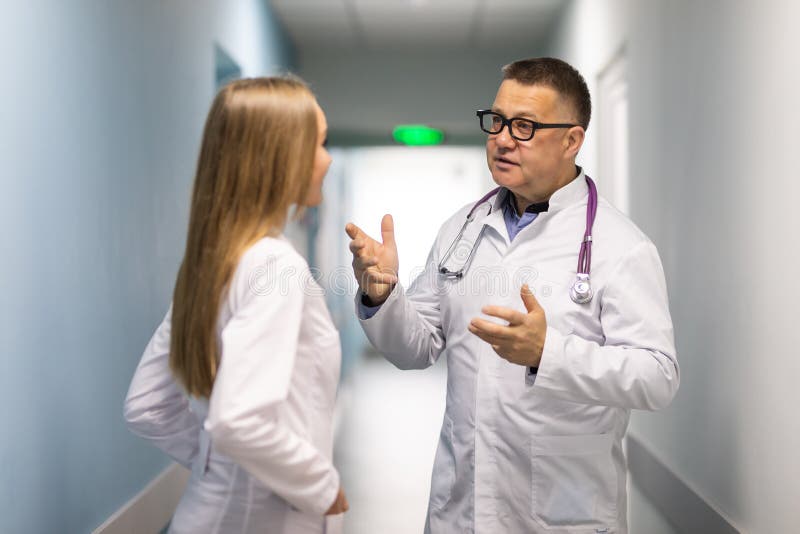 Medical Staff Having Discussion in Modern Hospital Corridor Stock Image ...