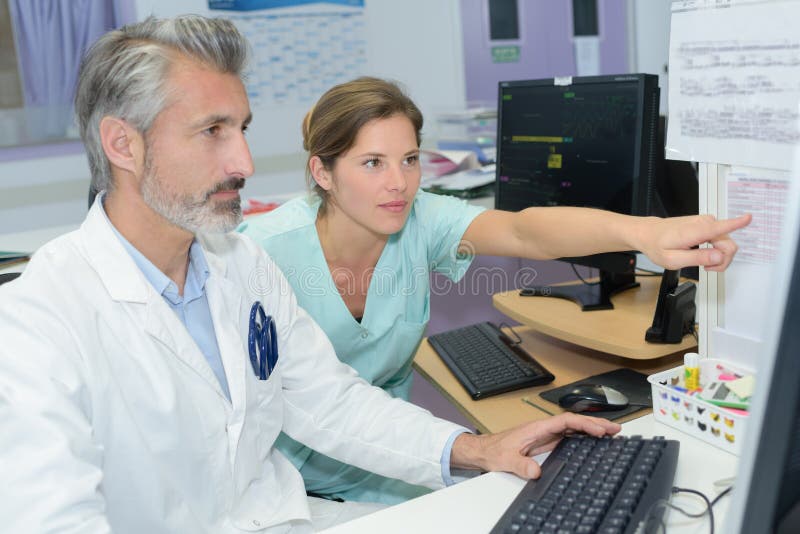 Medical Staff Using Computer and Pointing at Screen Stock Image - Image ...