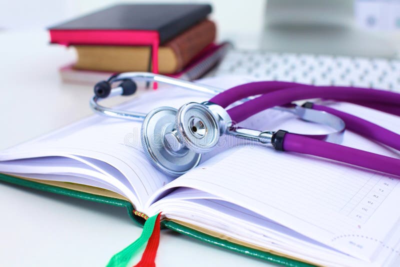 Medical Stethoscope with Old Books and Laptop on a Table Stock Photo ...
