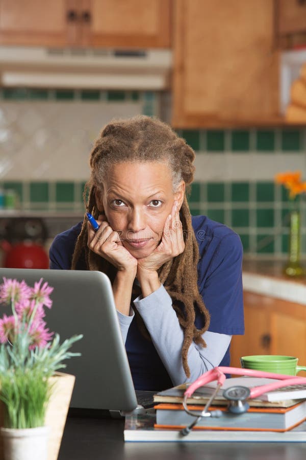 Medical Student Uses Laptop To Study at Her Kitchen Table Stock Image ...