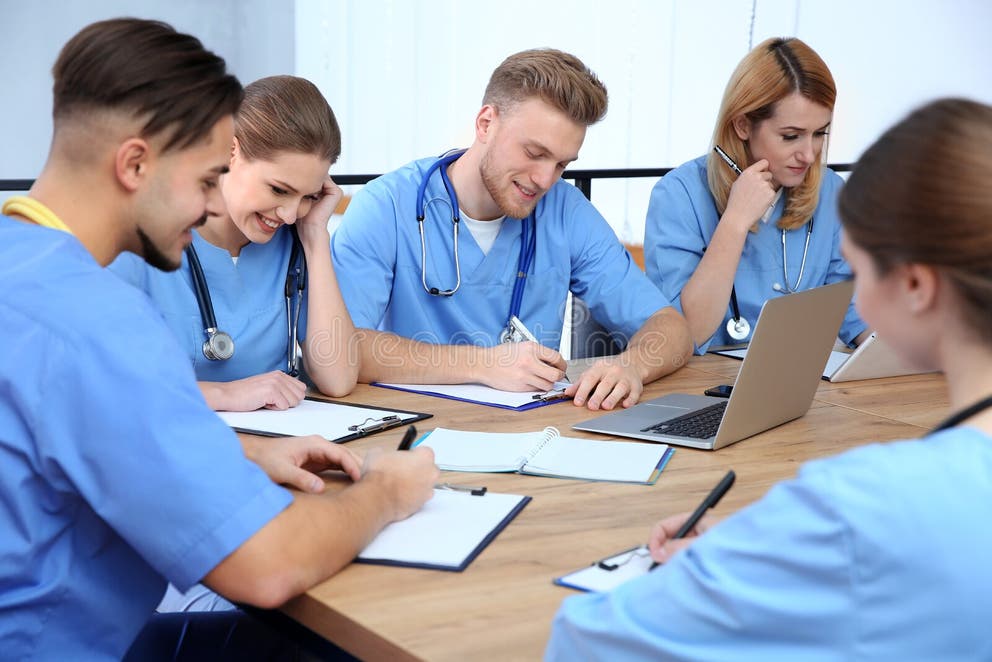 Medical Students in Uniforms Studying Stock Photo - Image of computer ...