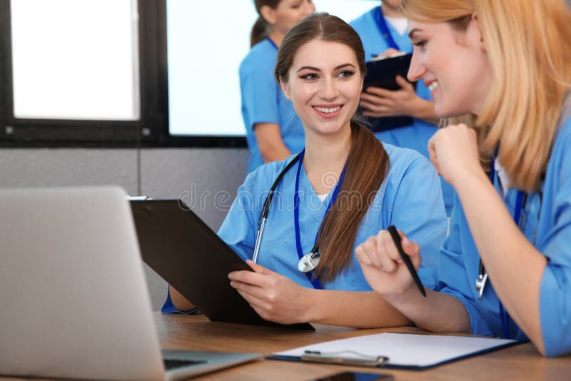 Medical Students in Uniforms Studying Stock Image - Image of groupmates ...