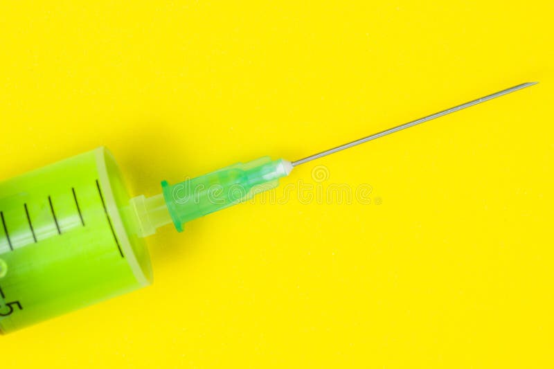 Medical Syringe with a Sharp Needle on a Yellow Background Stock Image ...
