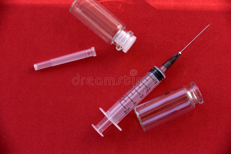 Medical Syringe Tablets and Glass Bubbles on a Red Background Stock ...