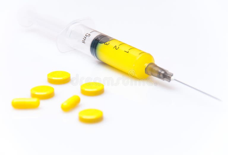 A Medical Syringe with a Yellow Solution Lies on a White Background ...
