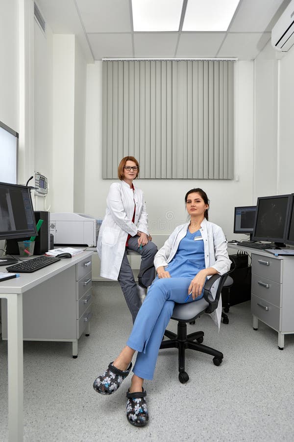Medical Team Discussing Around a Computer. Health Care Stock Photo ...