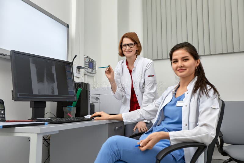 Medical Team Discussing Around a Computer. Health Care Stock Image ...
