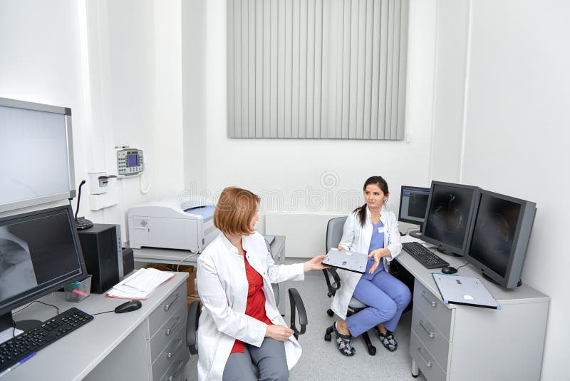 Medical Team Discussing Around a Computer. Health Care Stock Photo ...