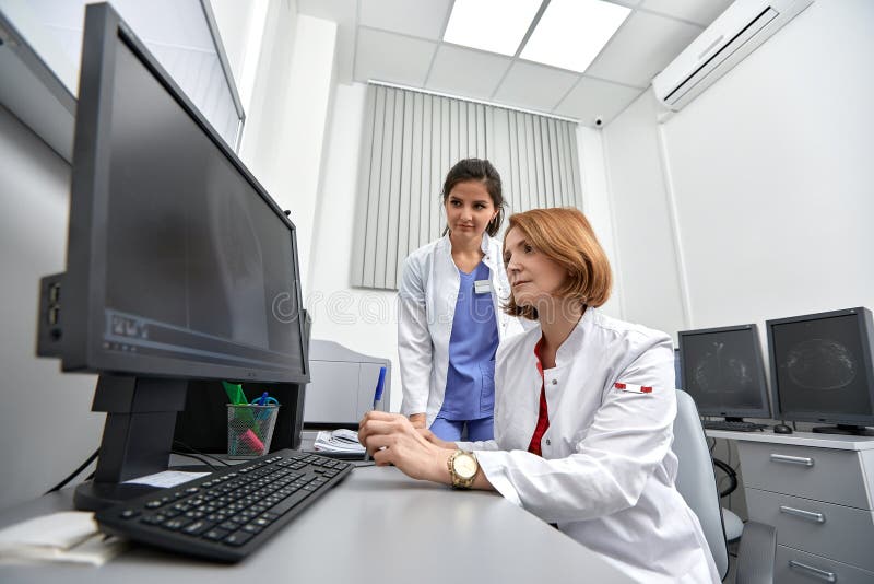 Medical Team Discussing Around a Computer. Health Care Stock Image ...