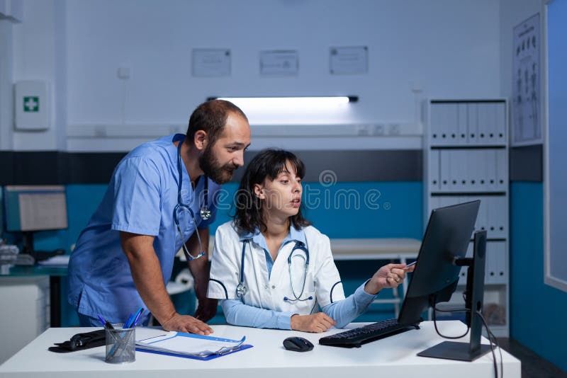 Medical Team Looking at Computer Screen for Checkup Information Stock ...
