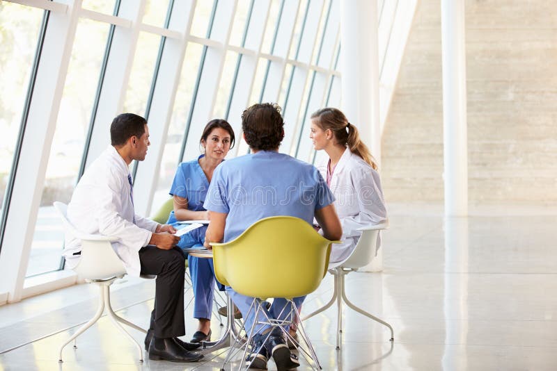 Medical Team Meeting Around Table in Hospital Stock Image - Image of ...