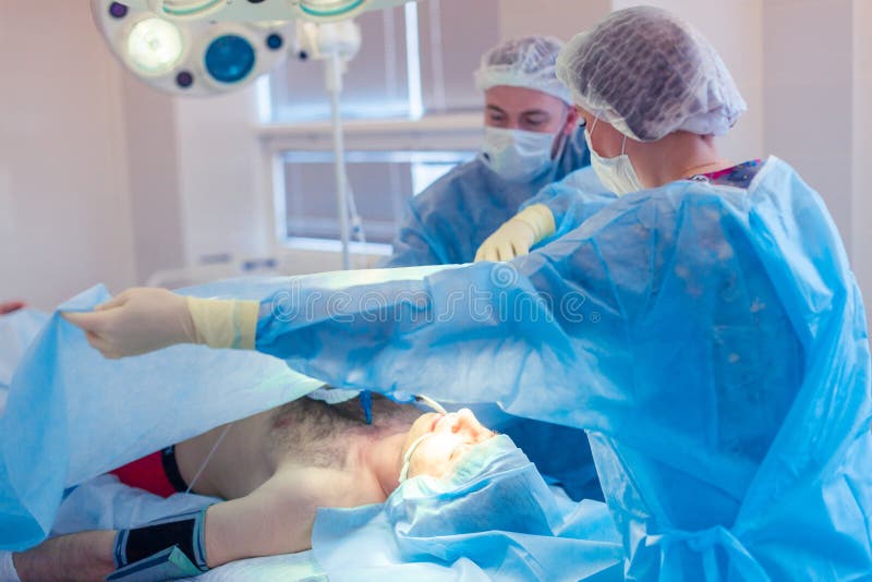 Medical Team Performing Surgical Operation in Modern Operating Room ...