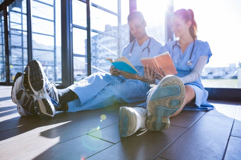 Medical team reading book stock photo. Image of health - 67725822