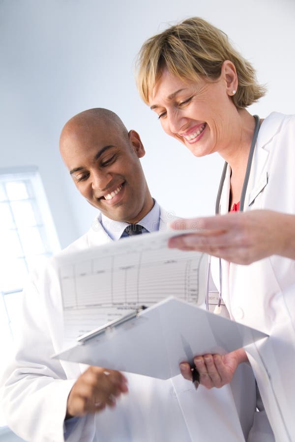 Medical Team Reviewing Chart Stock Photo - Image of reviewing ...