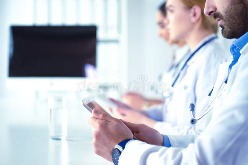 Medical Team Sitting and Discussing at Table Stock Image - Image of ...