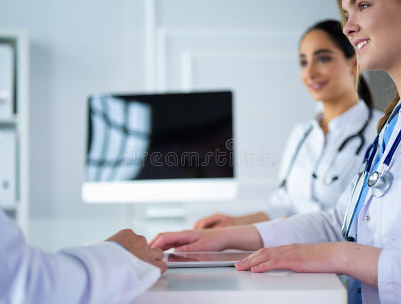 Medical Team Sitting and Discussing at Table Stock Photo - Image of ...