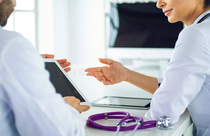 Medical Team Sitting and Discussing at Table Stock Photo - Image of ...