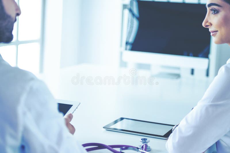 Medical Team Sitting and Discussing at Table Stock Image - Image of ...