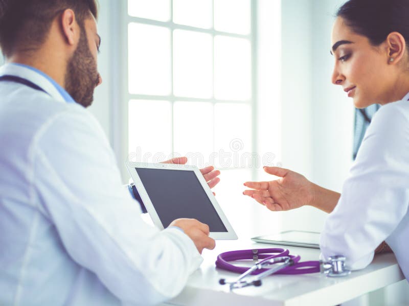 Medical Team Sitting and Discussing at Table Stock Photo - Image of ...