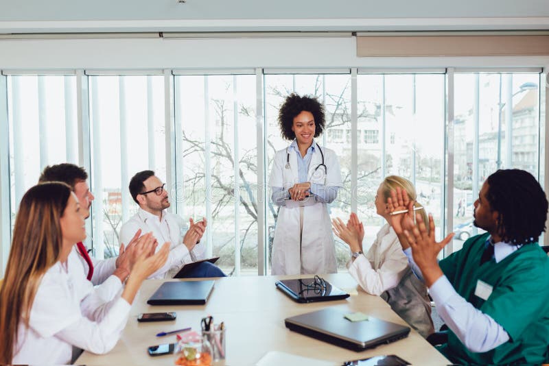 Medical Team Sitting and Discussing at the Table Stock Photo - Image of ...