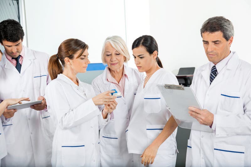 Medical Team with Patient at Reception Desk Stock Image - Image of desk ...