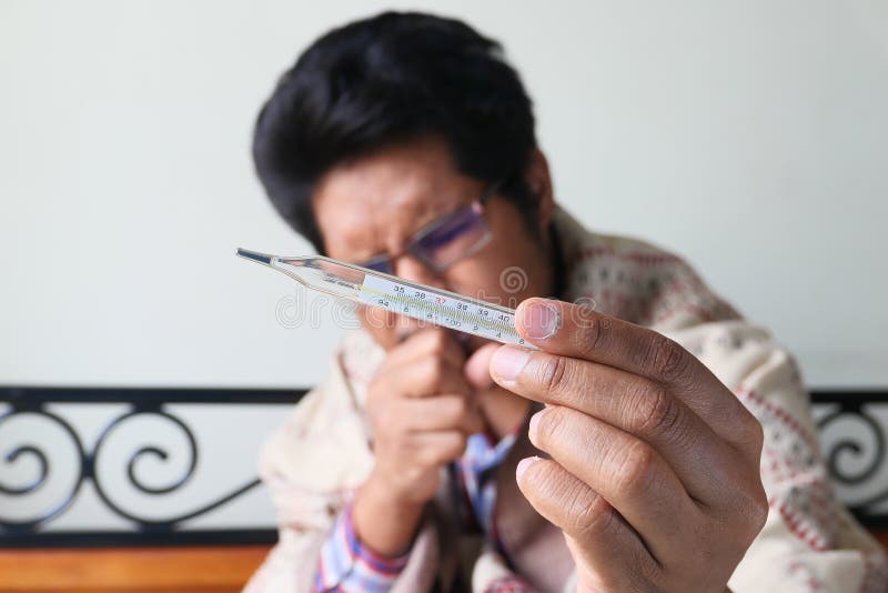 Medical Thermometer for Measuring Body Temperature in the Hand. Stock ...