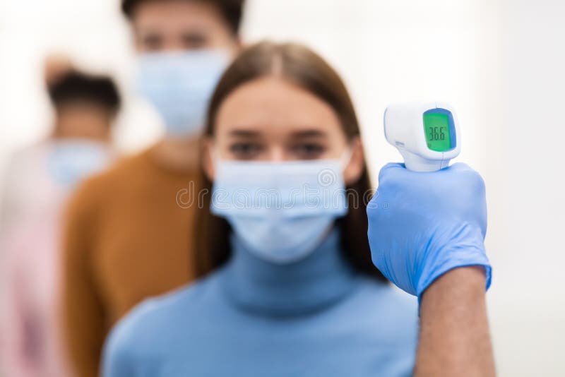 Medical Worker Doing Temperature Screening for Lady in Queue Indoor ...
