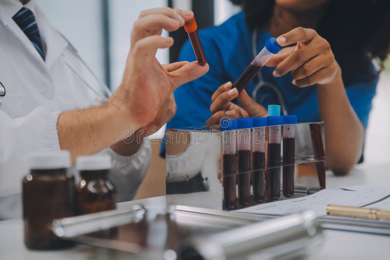 Medical Worker in Lab Coat and Sterile Mask, Doing a Microscope ...