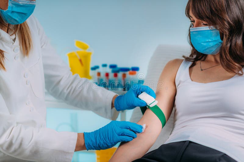 Medical Worker with PPE Taking Blood Sample from Patient in a Hospital ...