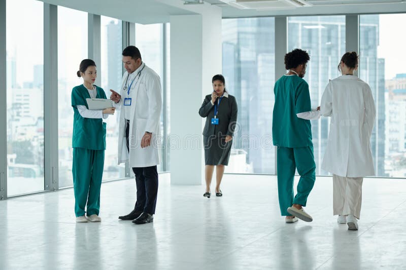 Medical Workers Cooperating in Hospital Corridor Stock Photo - Image of ...