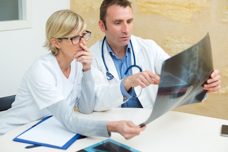 Medical Workers in Office Conferring Over Xray Stock Image - Image of ...