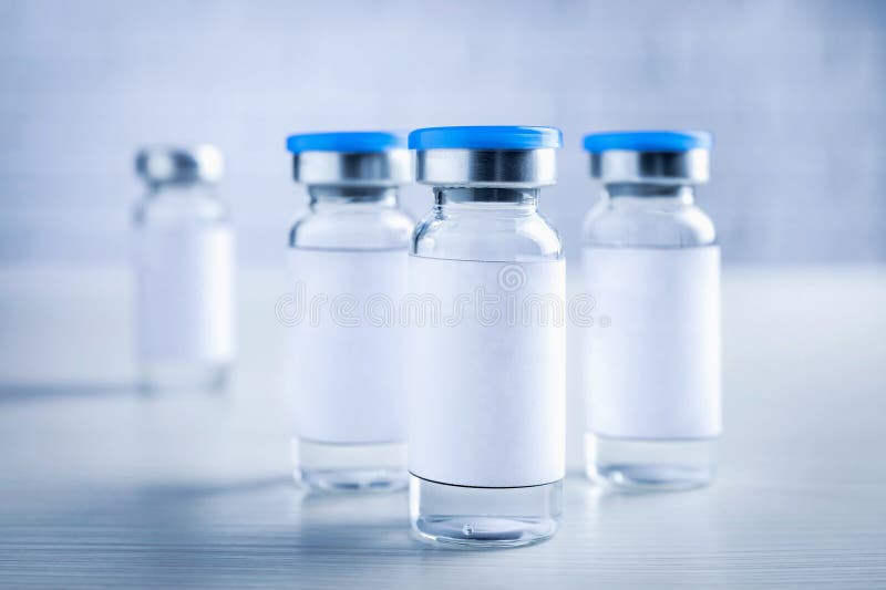 Medication in Glass Vials with Blank Labels on White Wooden Table Stock ...