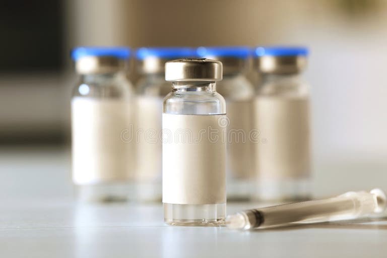 Medication in Vials and Syringe on Table, Space for Text Stock Photo ...