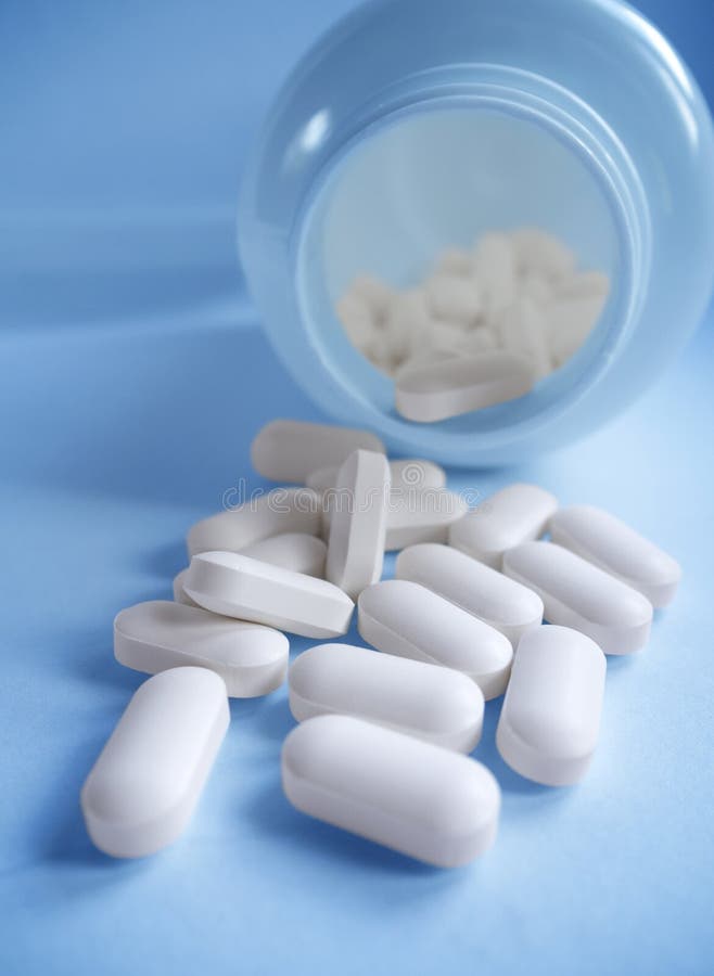 Medicinal Pills they are Located Inside the Blue Bottle Container Close ...