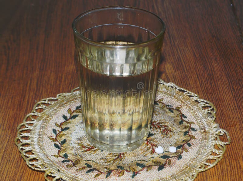 Medicinal Tablets and Glass of Water on the Table Stock Image - Image ...
