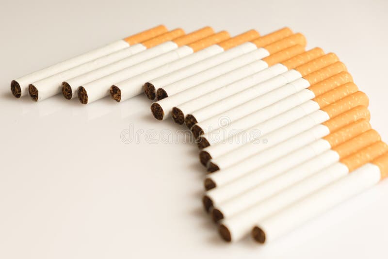 Cigarettes with a Yellow Filter Lie on a White Surface Stock Photo ...