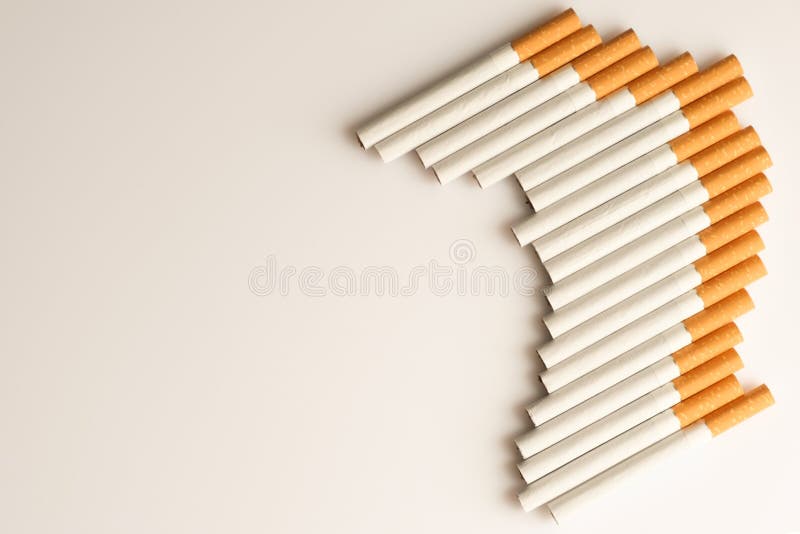 Cigarettes with a Yellow Filter Lie on a White Surface Stock Photo ...
