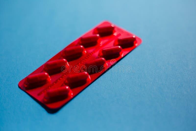 Medicine Pills Capsules, Red Pack Over Blue. Stock Photo - Image of ...