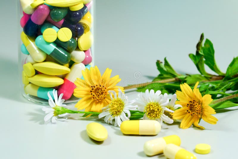 Medicine Pills with Yellow and White Flower. Stock Photo - Image of ...