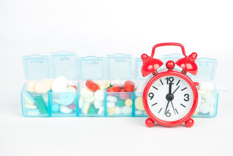 Medicine in Weekly Pill Box and Red Alarm Clock Stock Image - Image of ...