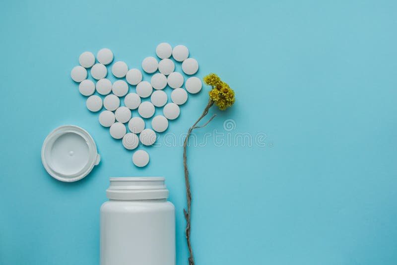 Medicines White Round Heart Shaped Pills On Blue Background Stock
