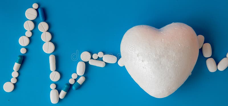 Medicines White Round Heart Shaped Pills Isolated On Blue Background