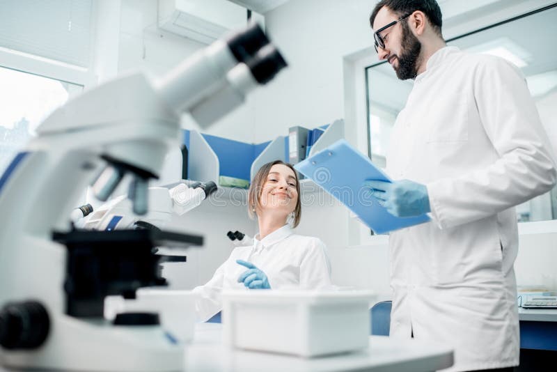 Medics Working with Microscope at the Laboratory Stock Image - Image of ...