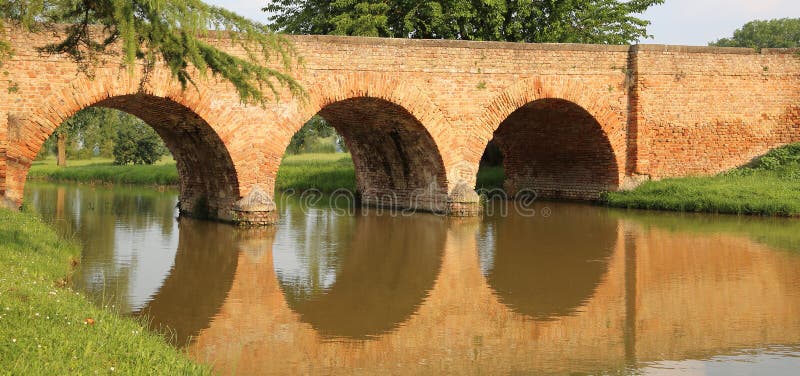 Medieval Bridge Made of Red Brick with Arches Over the River Stock ...