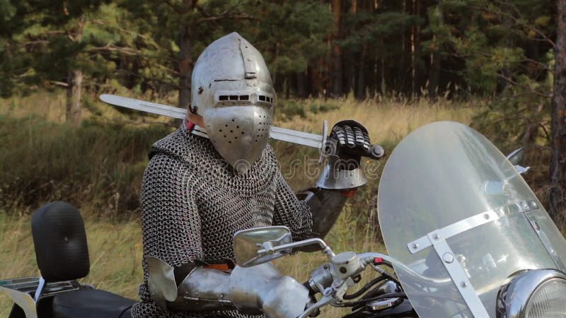 A Medieval Knight in Full Armor Sits on a Motorcycle Against the ...